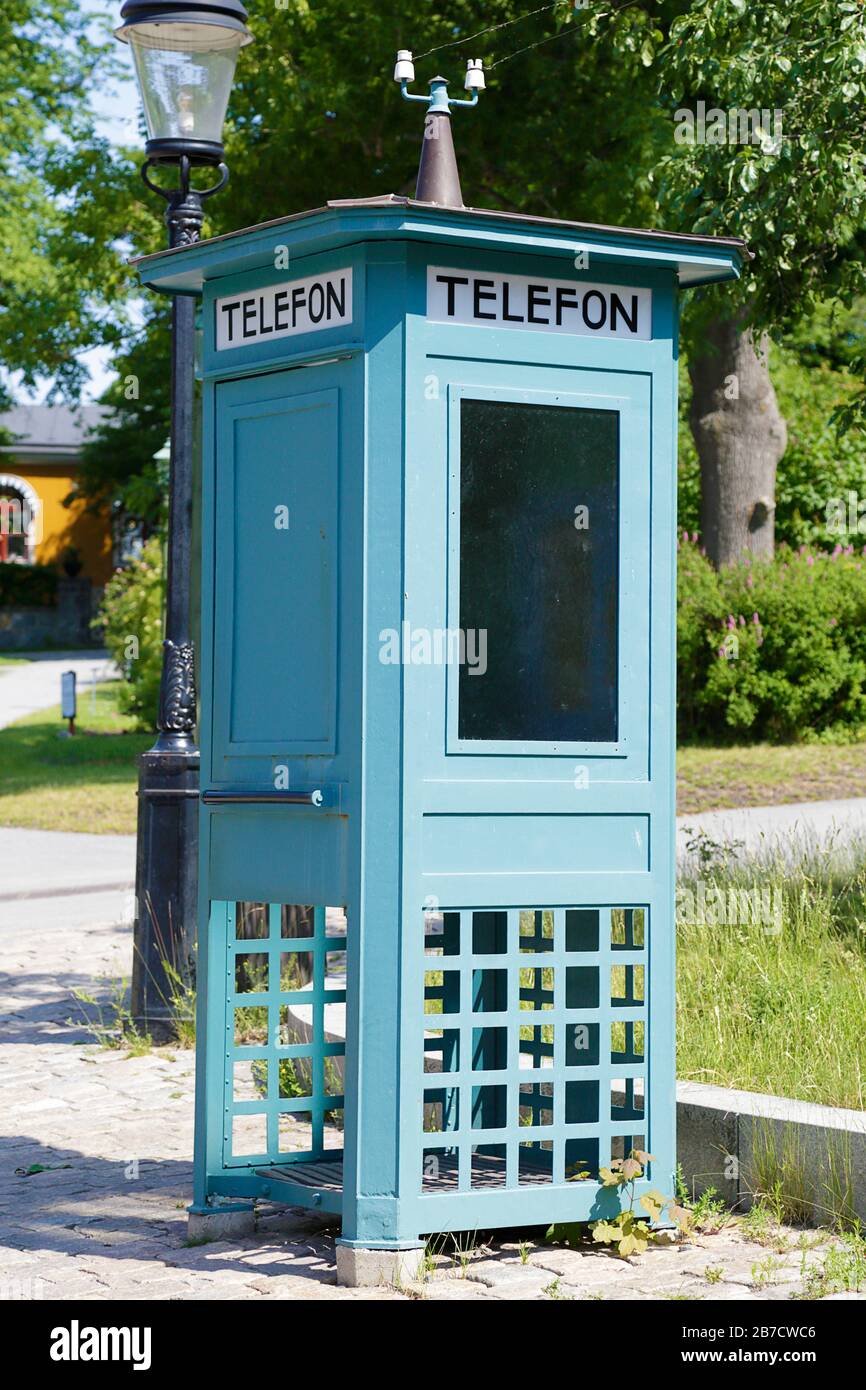 Antique wooden phone booth with the word telephone written in swedish ...