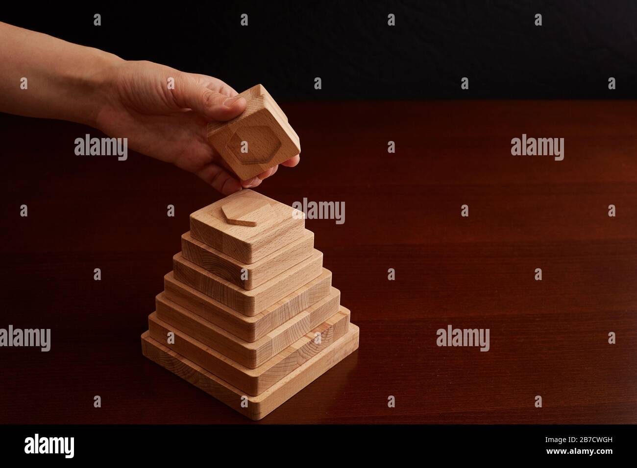 Toy made of beech wood. manual work on the cnc machine. pyramid with ...