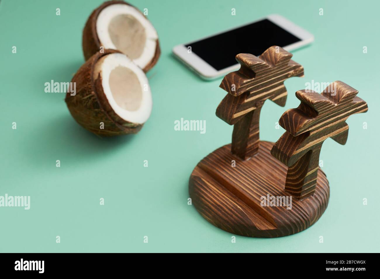 Wooden hand made stand for the phone. Wooden palm trees, coconuts ...