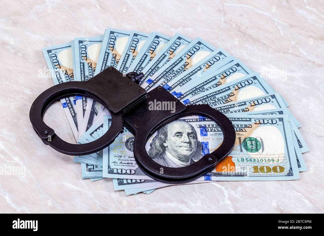Steel police handcuffs lying on the background of american dollars ...