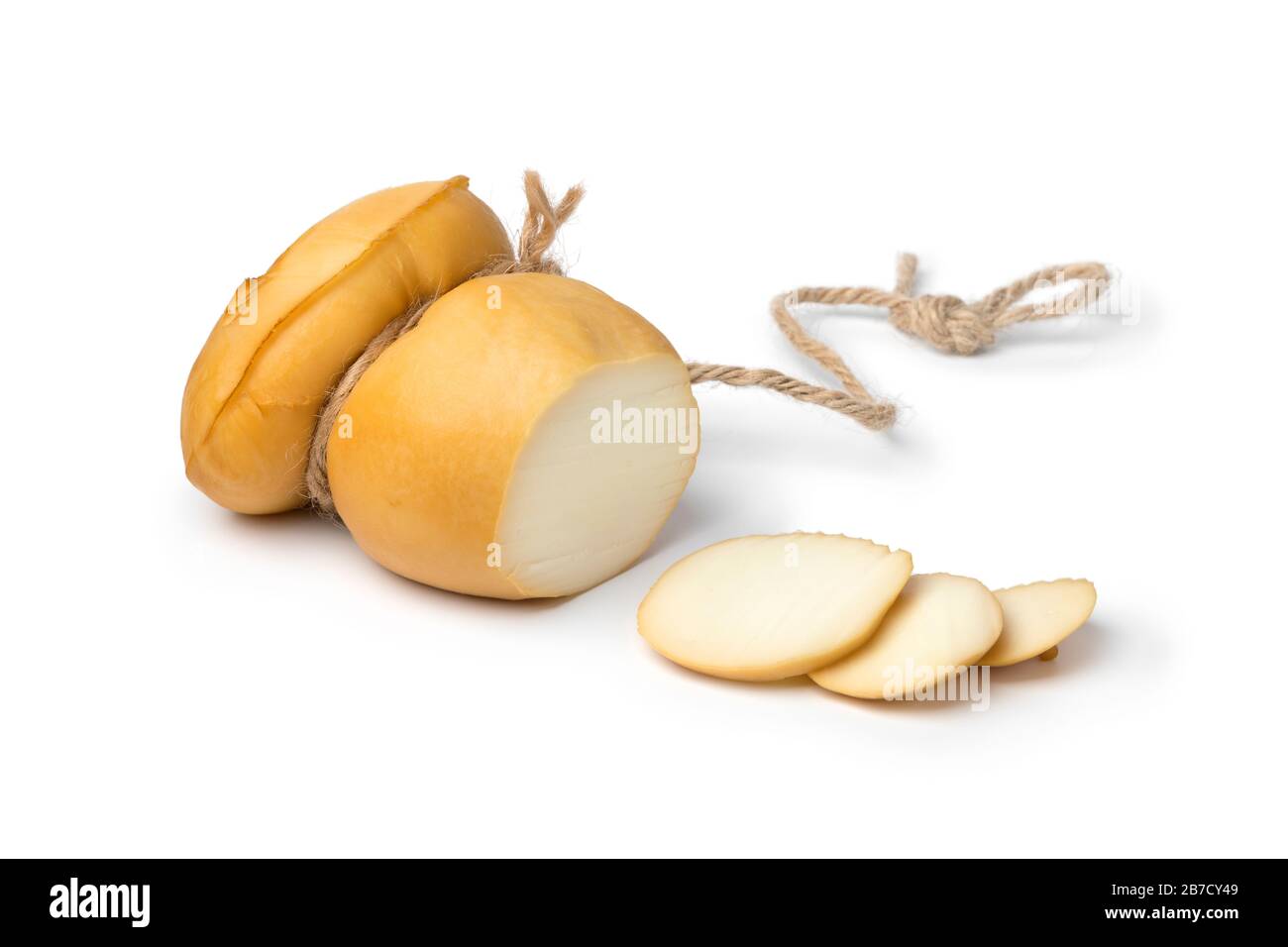 Whole Italian Scamorza Affumicata and slices close up at white ...