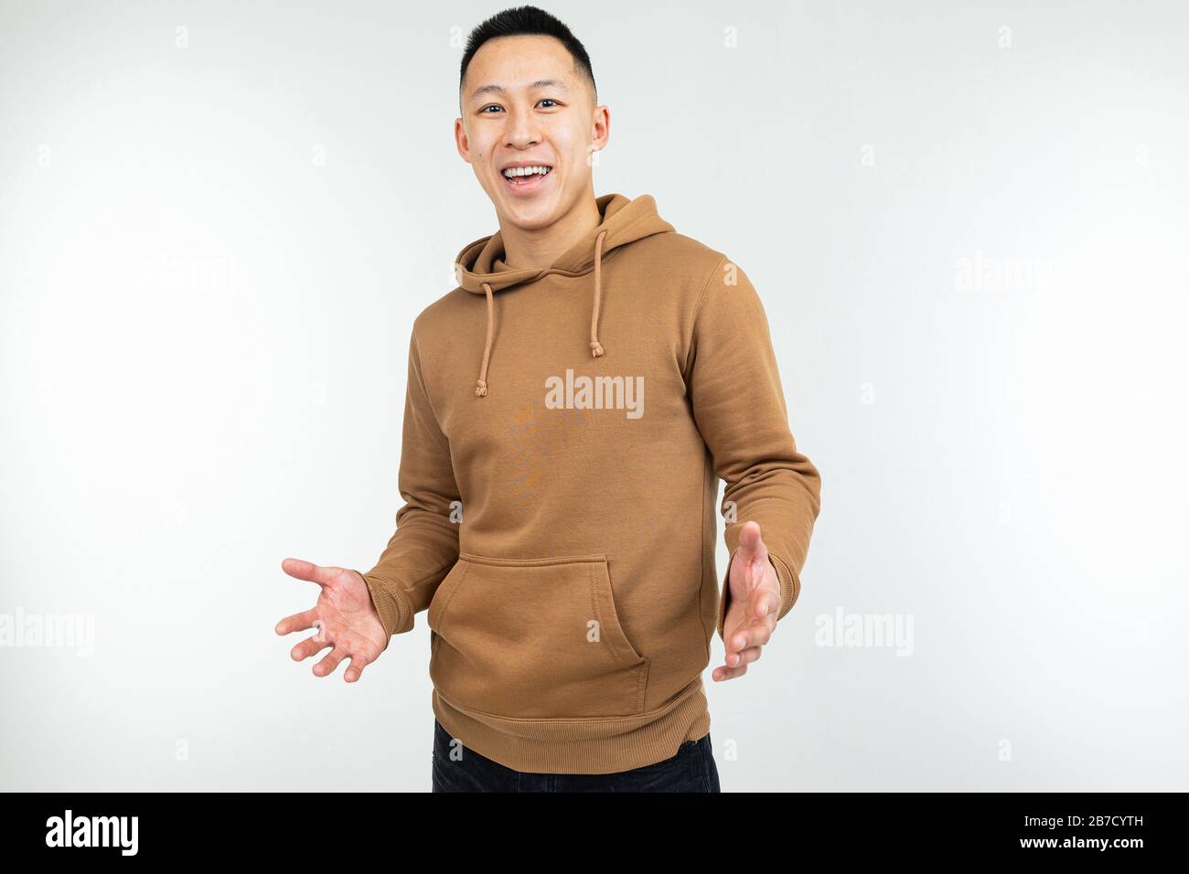 smiling man in brown hoodie with open arms on a white background Stock ...