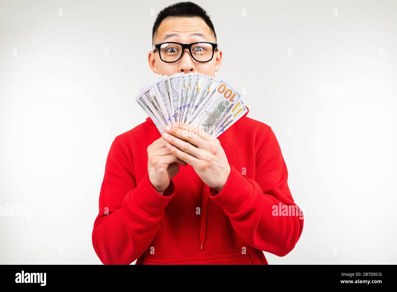joyful man with a fan of money on a white background Stock Photo - Alamy