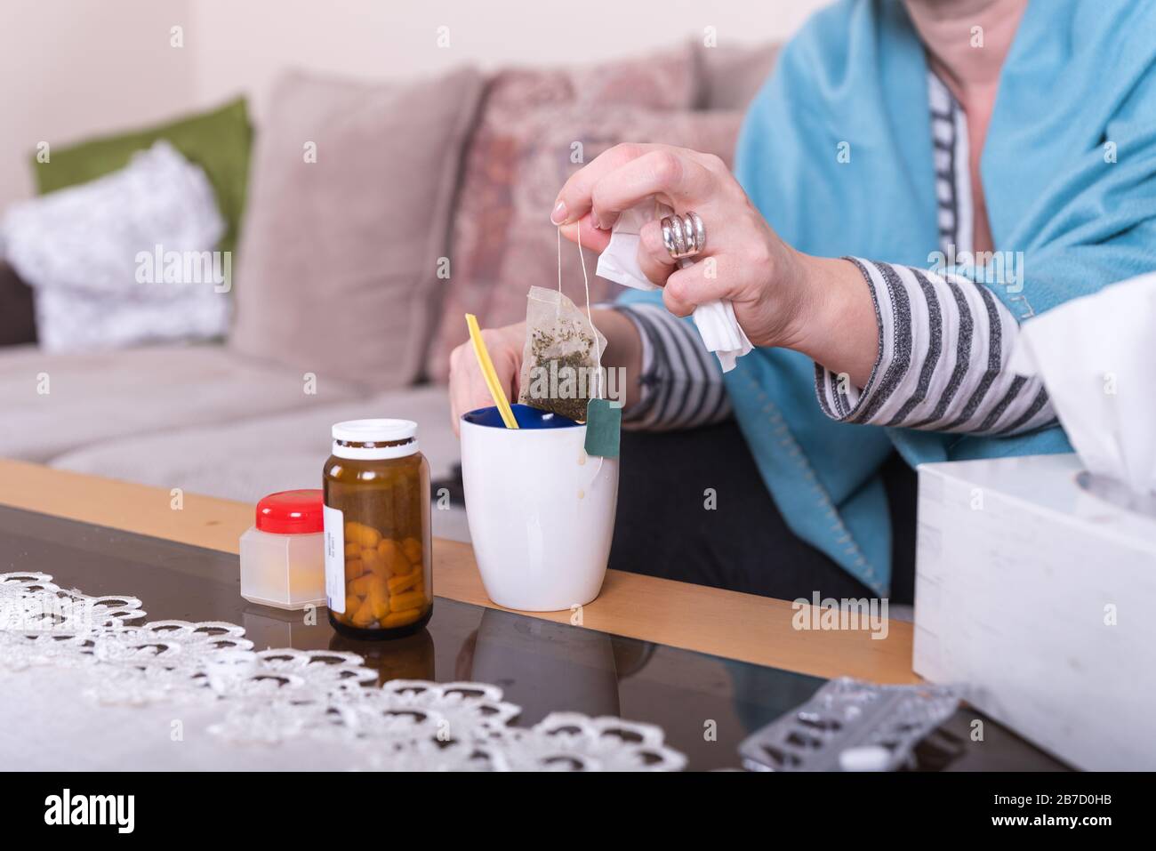A very sick woman with temperature drinks warm tea Stock Photo - Alamy