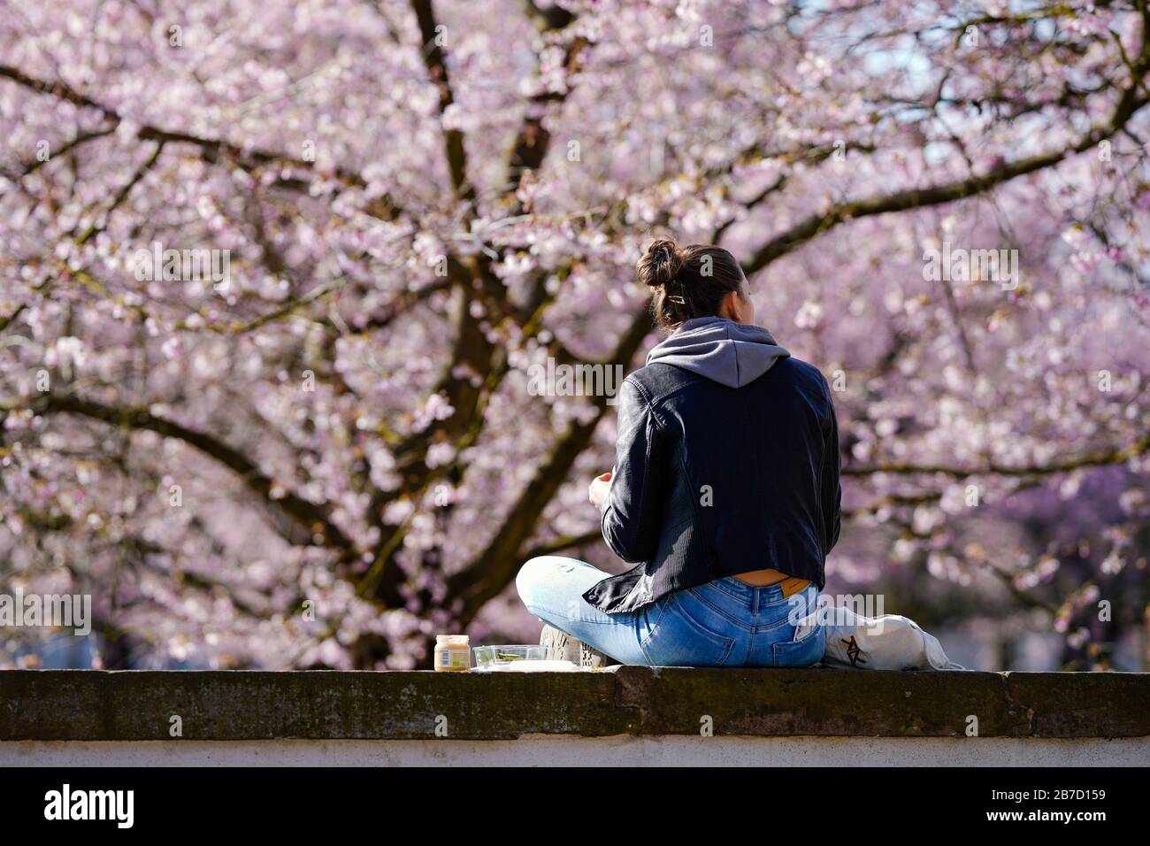 Schwetzingen, Germany. 15th Mar, 2020. A visitor sits in the castle ...