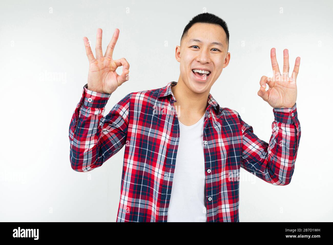 Asian man in a checkered shirt wide open shows super on an isolated ...