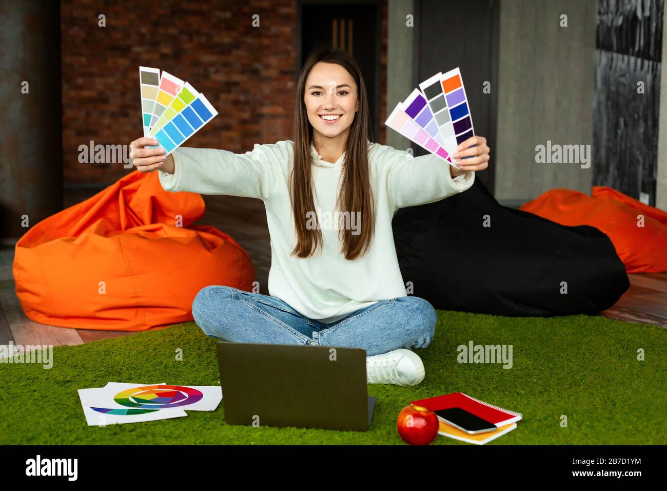 Freelancer girl designer shows a lot color swatch Stock Photo - Alamy