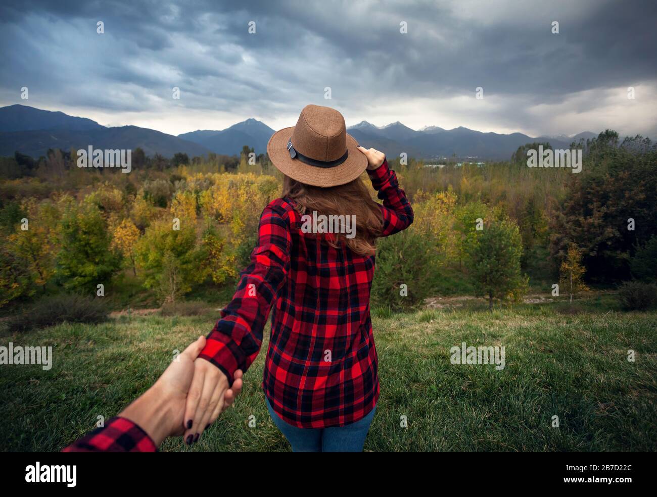 Holding hat in wind hi-res stock photography and images - Alamy