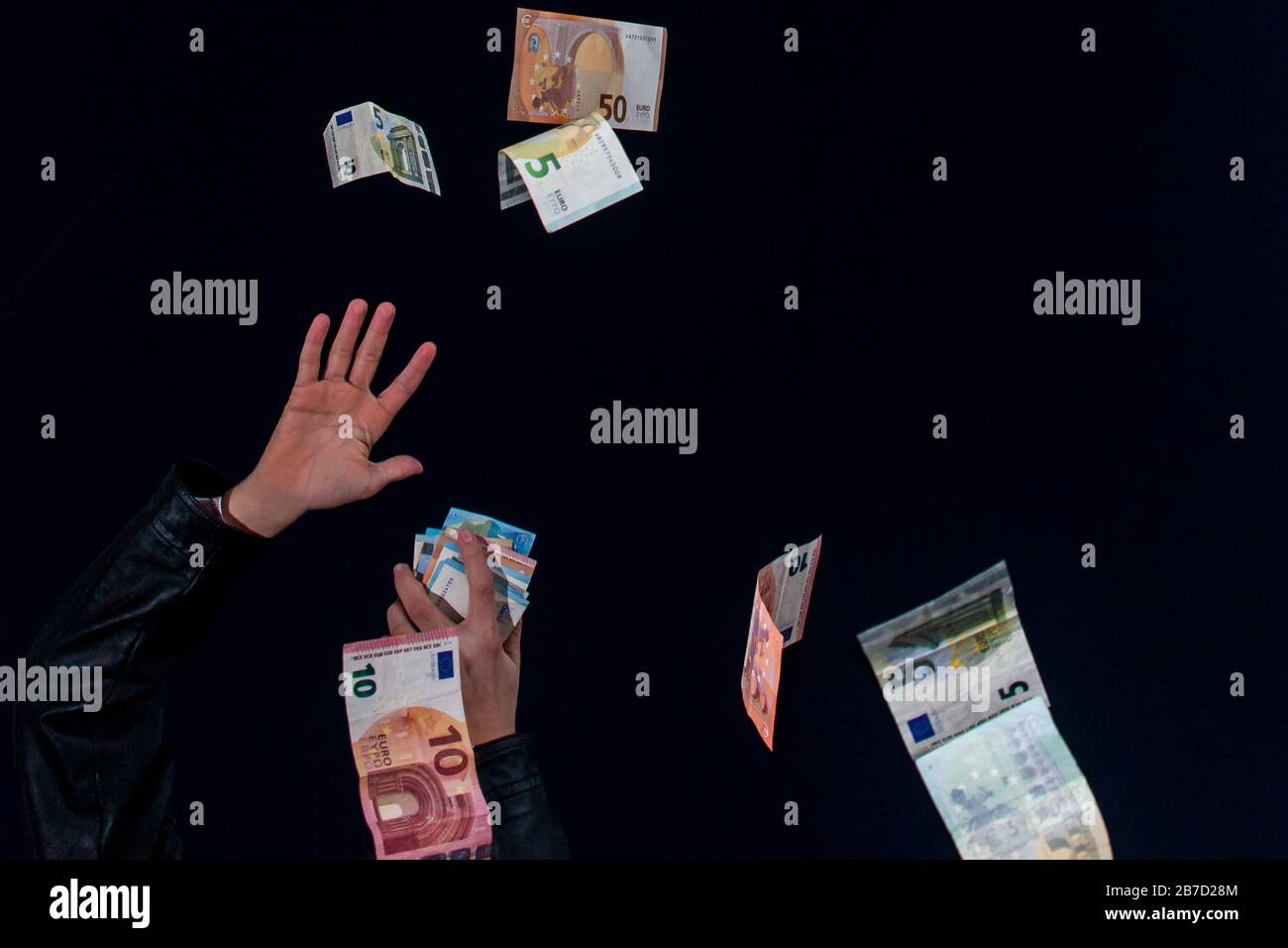 Taking money that falls from the sky flying bills at night Stock Photo ...