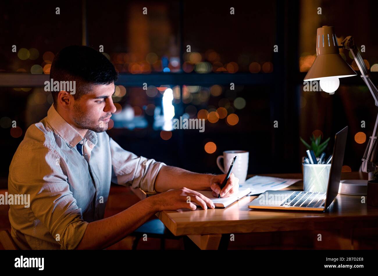 Business Guy Taking Notes Working Overnight Sitting In Office, Low ...
