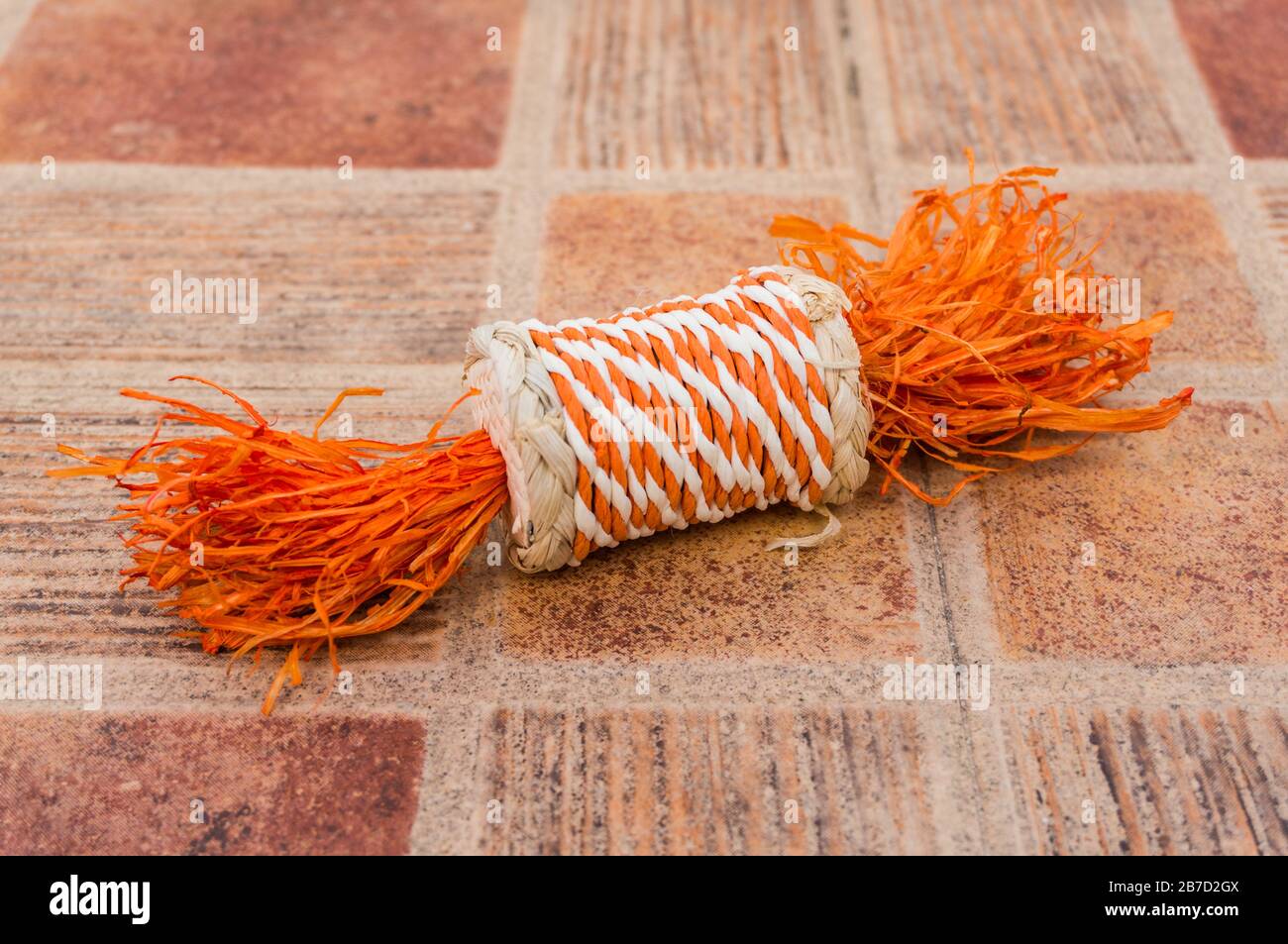 Rope rodent toy to bite white and orange Stock Photo - Alamy