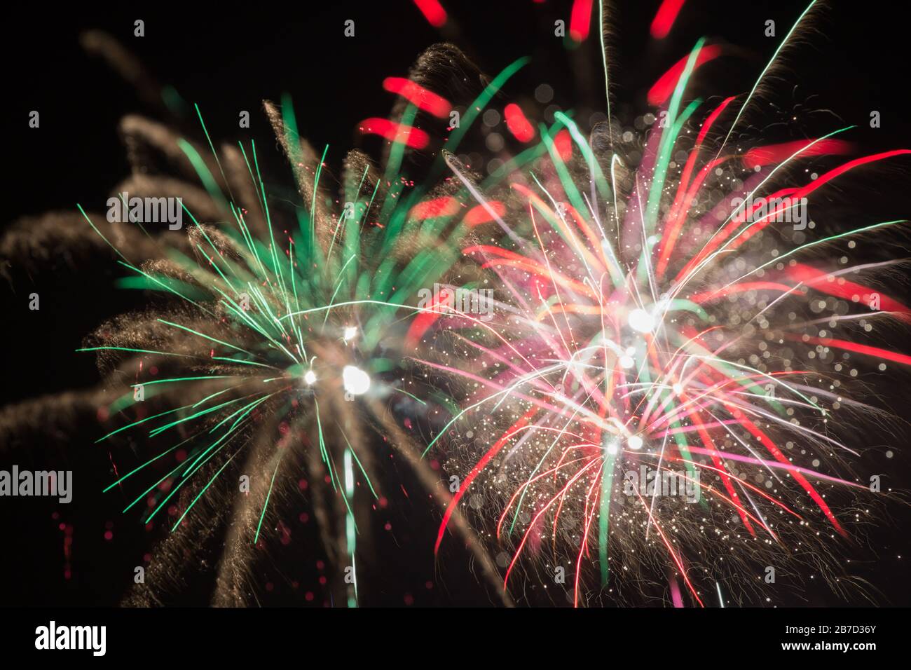 Night burst of beautiful firework celebration with colorful glow ...