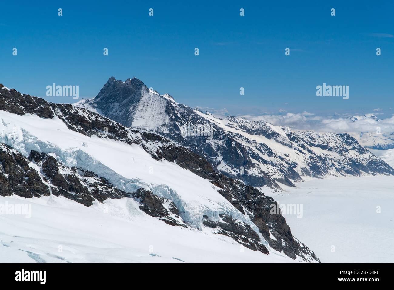 Panoramic view on winter snowy mountains at nice sunny evening. Swiis ...