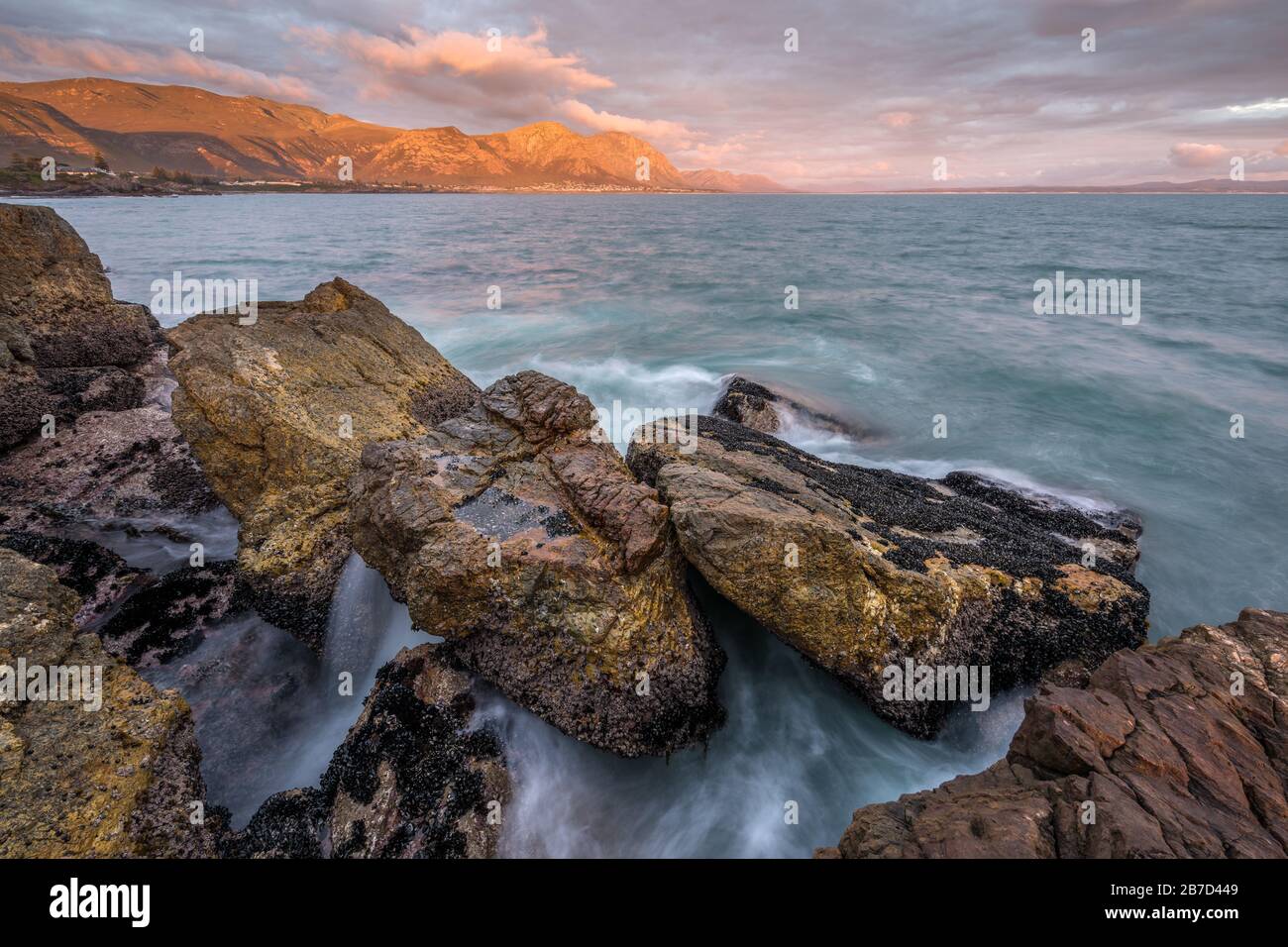 A beautiful golden seascape photographed on a stormy day at sunset in ...