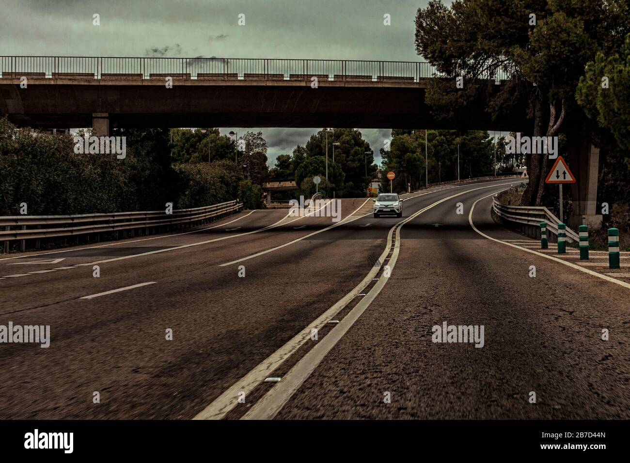 Car on the road with bridge and traffic signs Stock Photo - Alamy