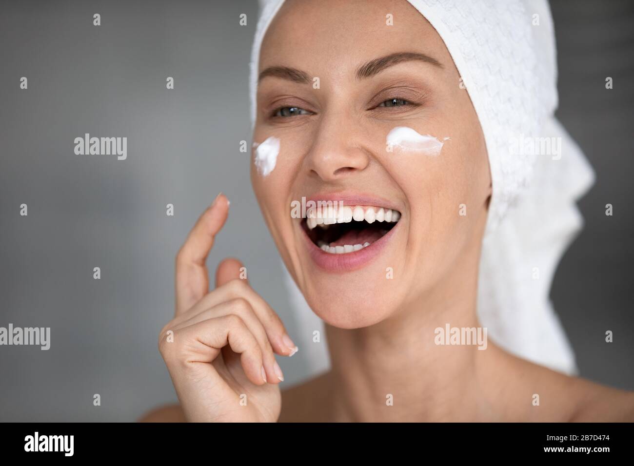 Happy lady grooming herself in bathroom, skincare routine Stock Photo ...