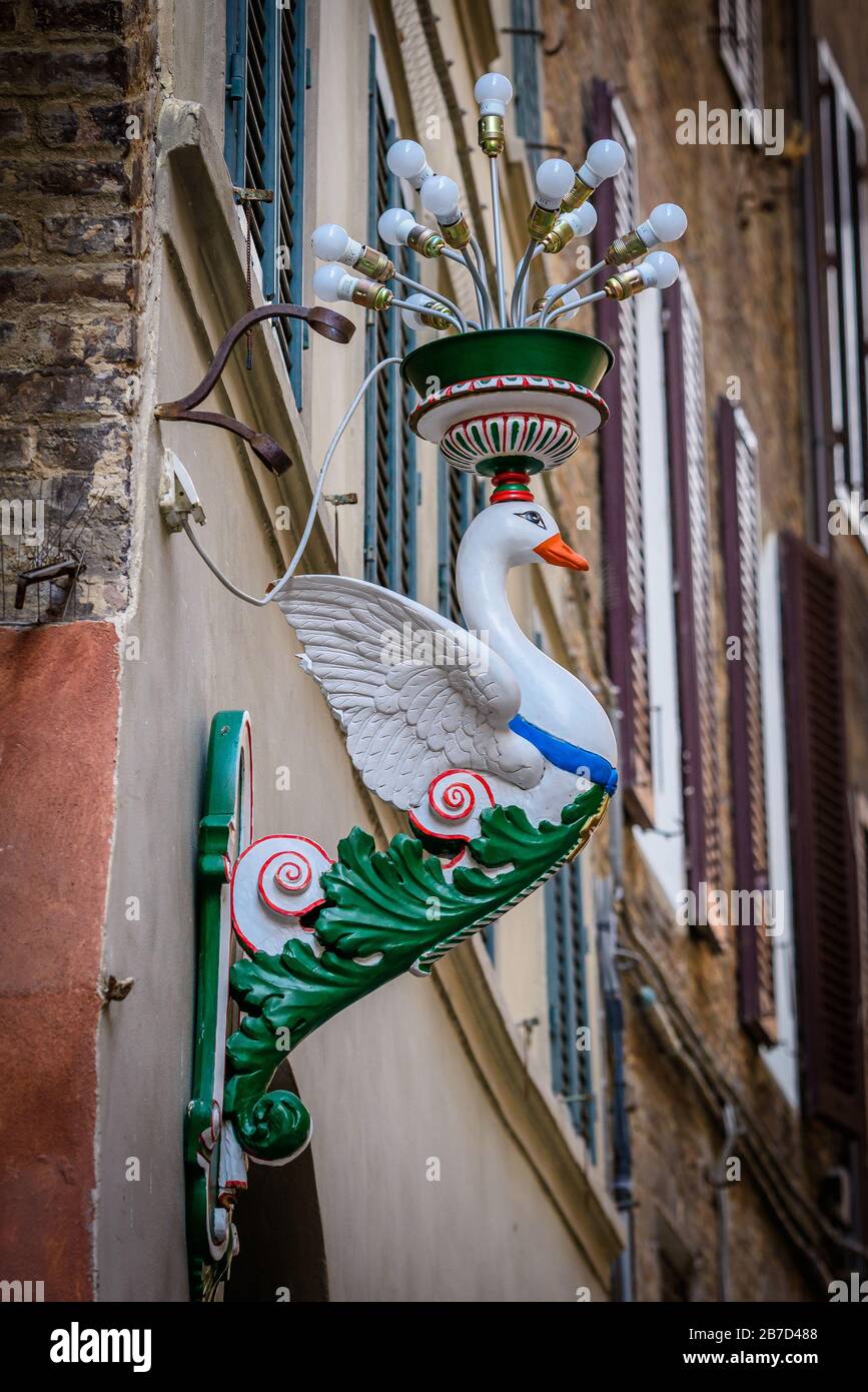 Ornate swan-shaped street light in the historic centre of Siena ...