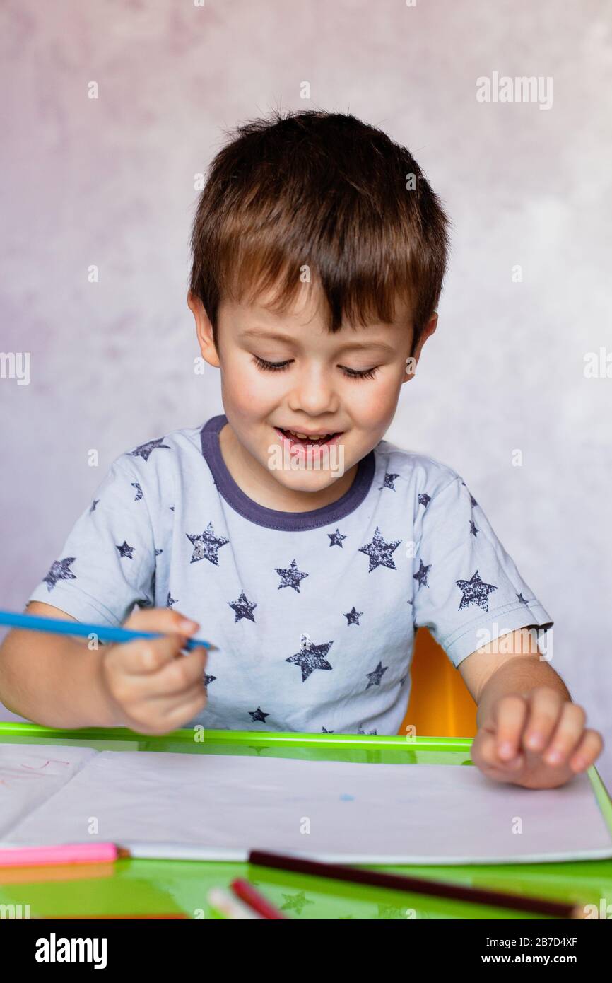 Little boy drawing with color pencils. Little boy is holding color ...