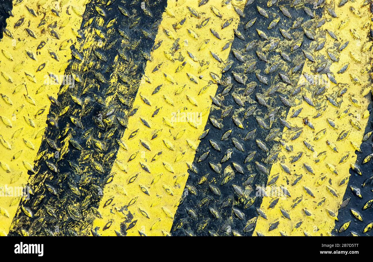 Black and yellow line paint on non-slip metal textured background Stock ...