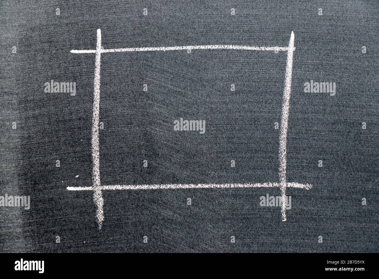 White color chalk hand drawing in square shape on black board ...