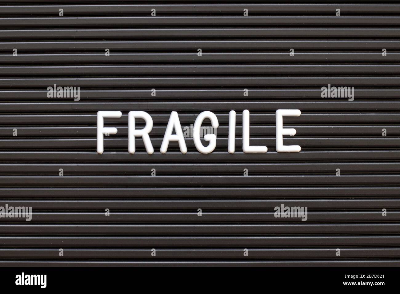 Black color felt letter board with white alphabet in word fragile ...