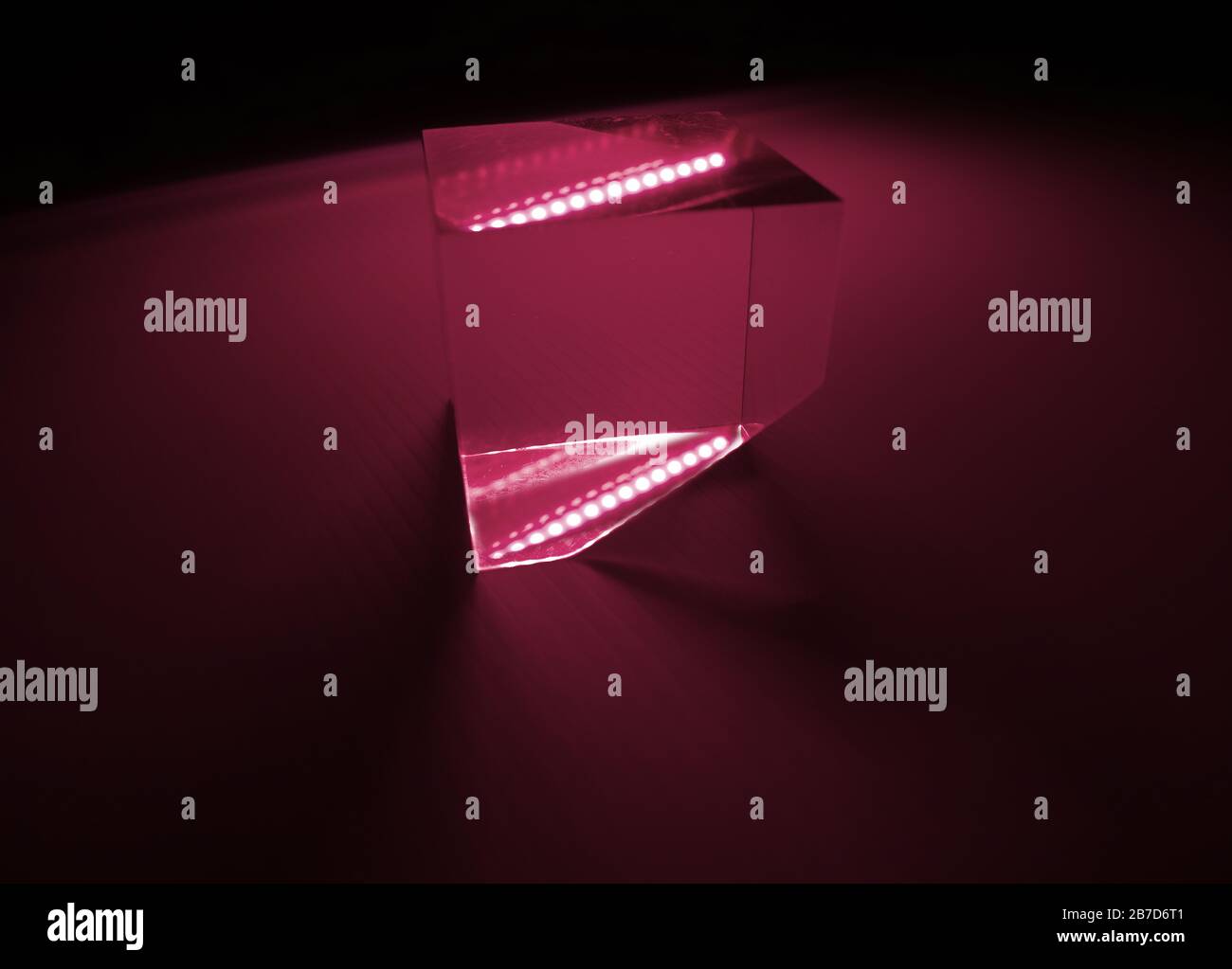 A transparent 3D prism lit with a red light Stock Photo - Alamy