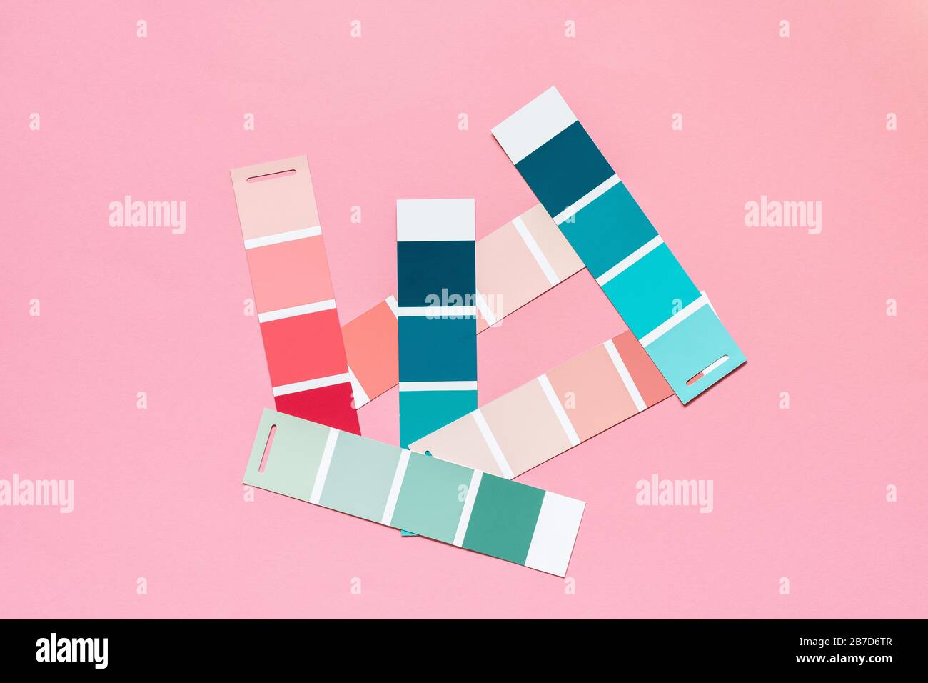 Selection of palette for painting, sample color catalog on a pink ...