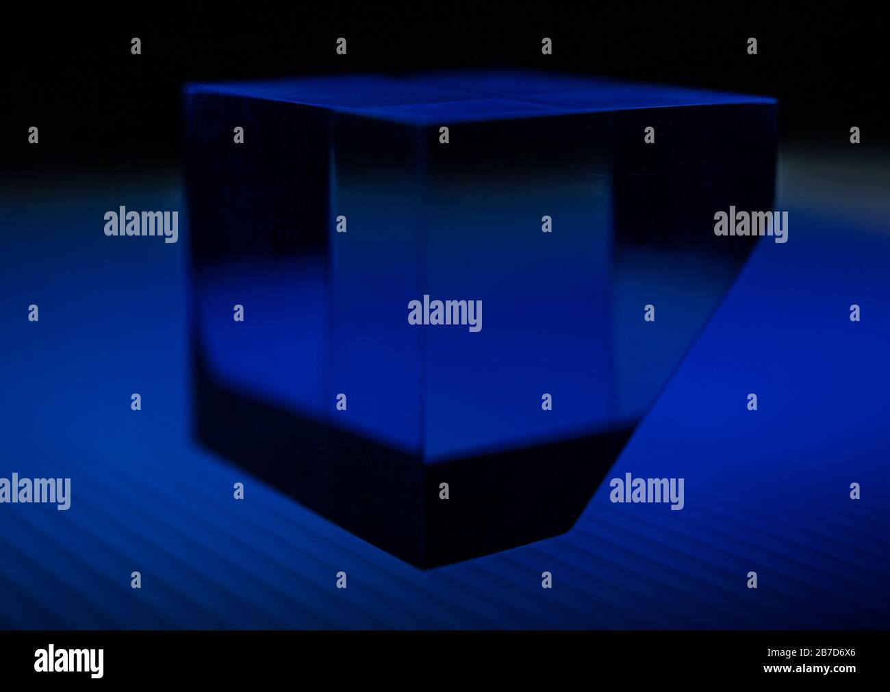 A transparent geometric object, lit in blue Stock Photo - Alamy