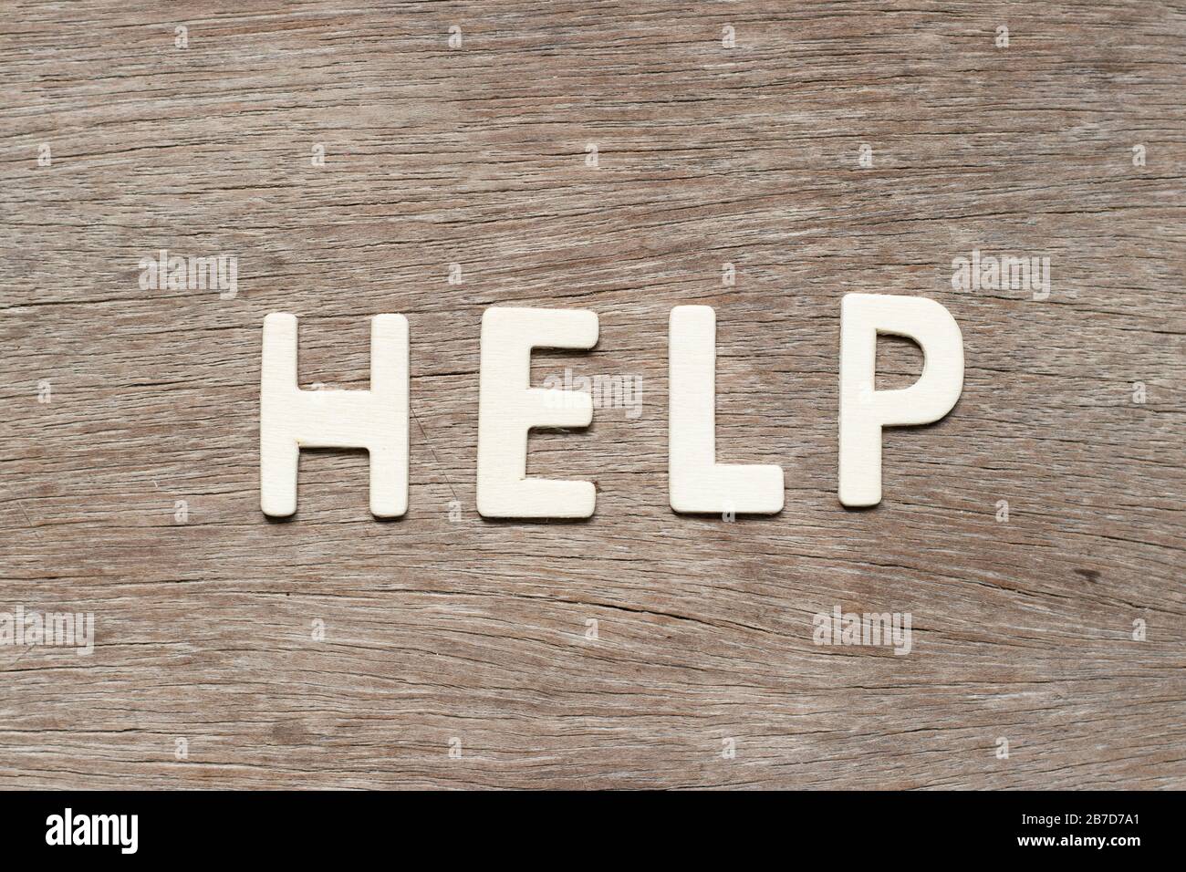 Alphabet letter in word help on wood background Stock Photo - Alamy