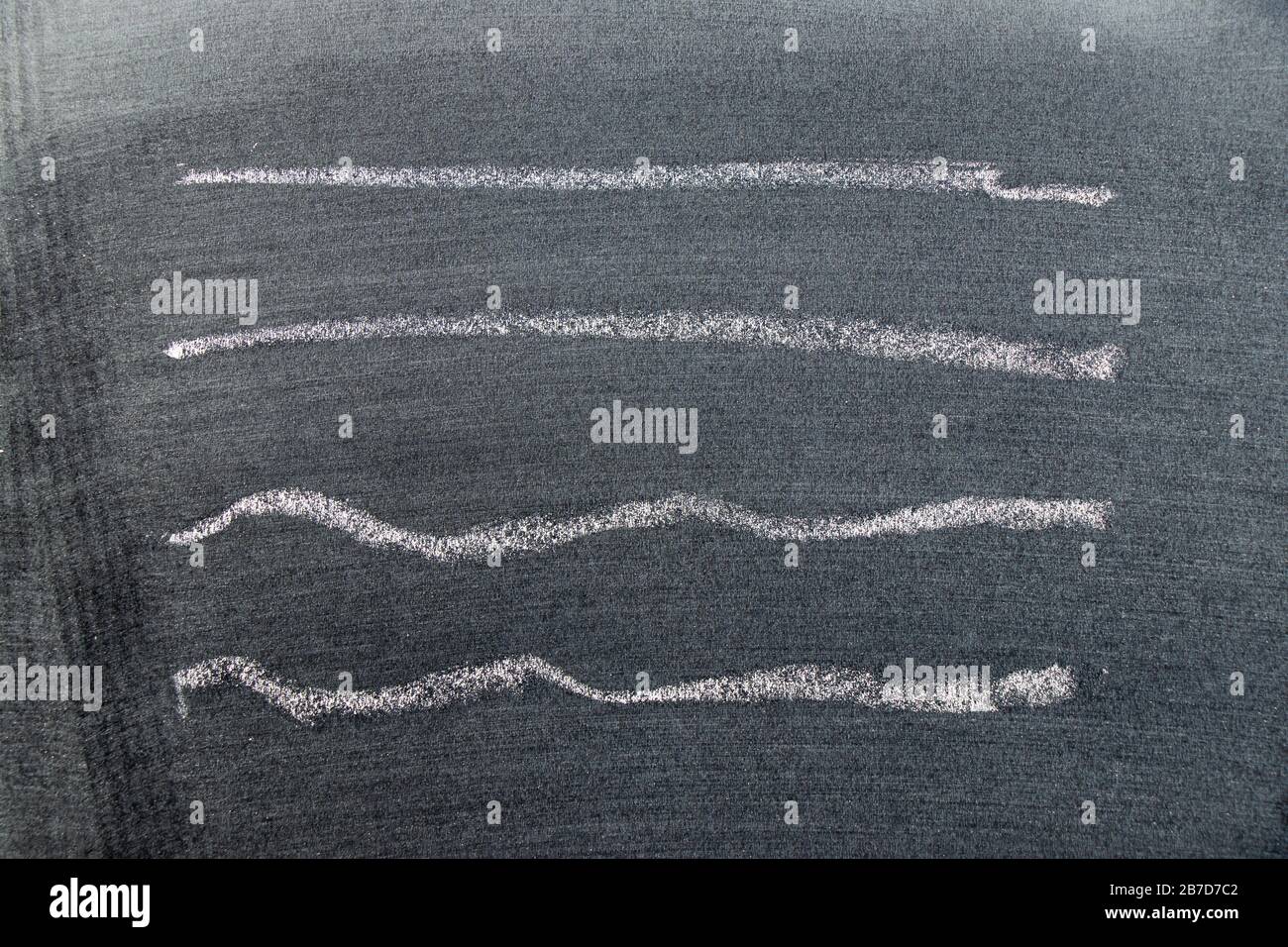 White color chalk hand drawing in set of line shape on black board ...