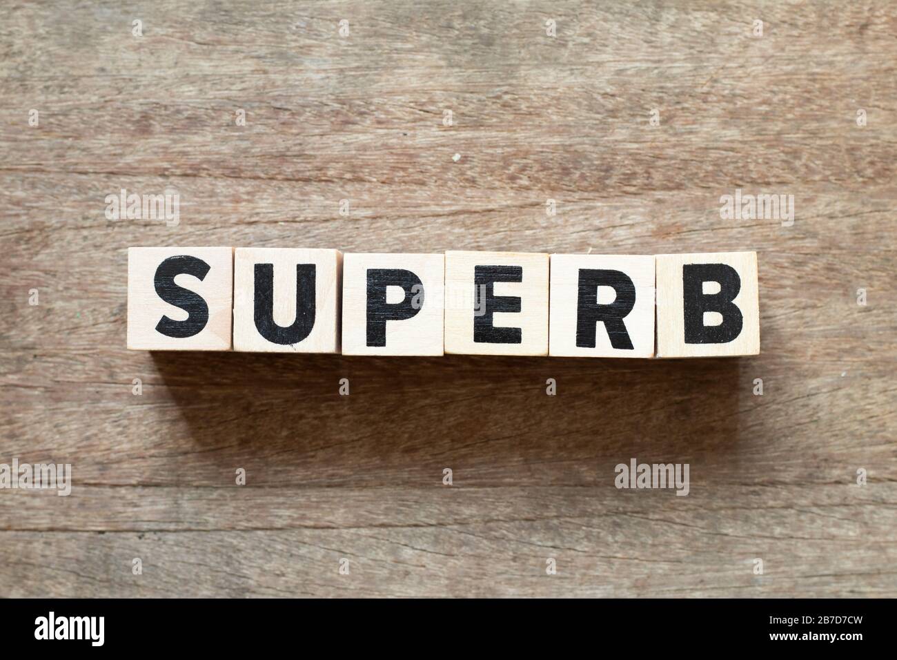 Letter block in word superb on wood background Stock Photo - Alamy