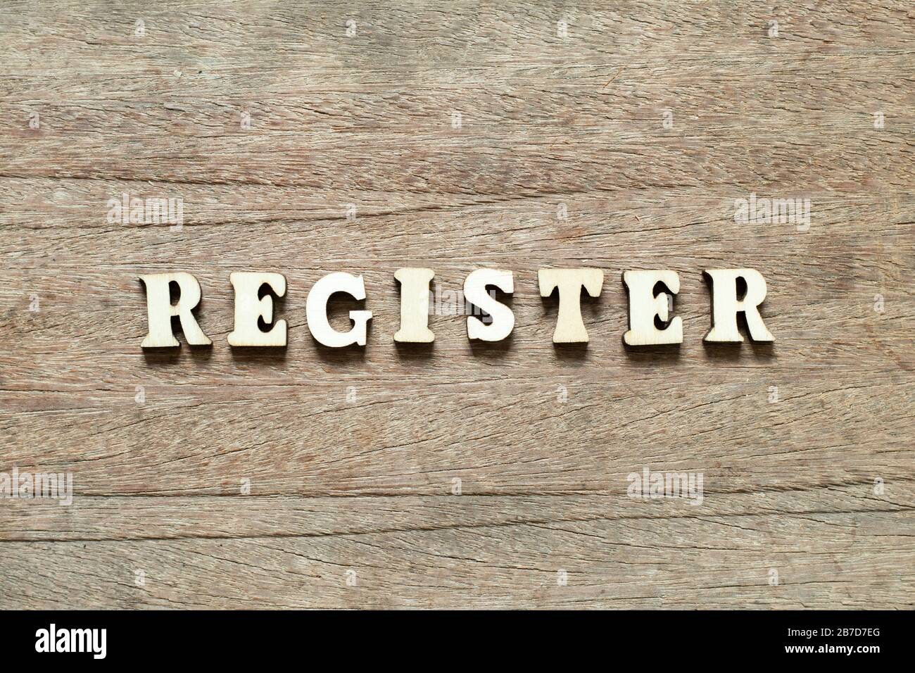 Letter block in word register on wood background Stock Photo - Alamy