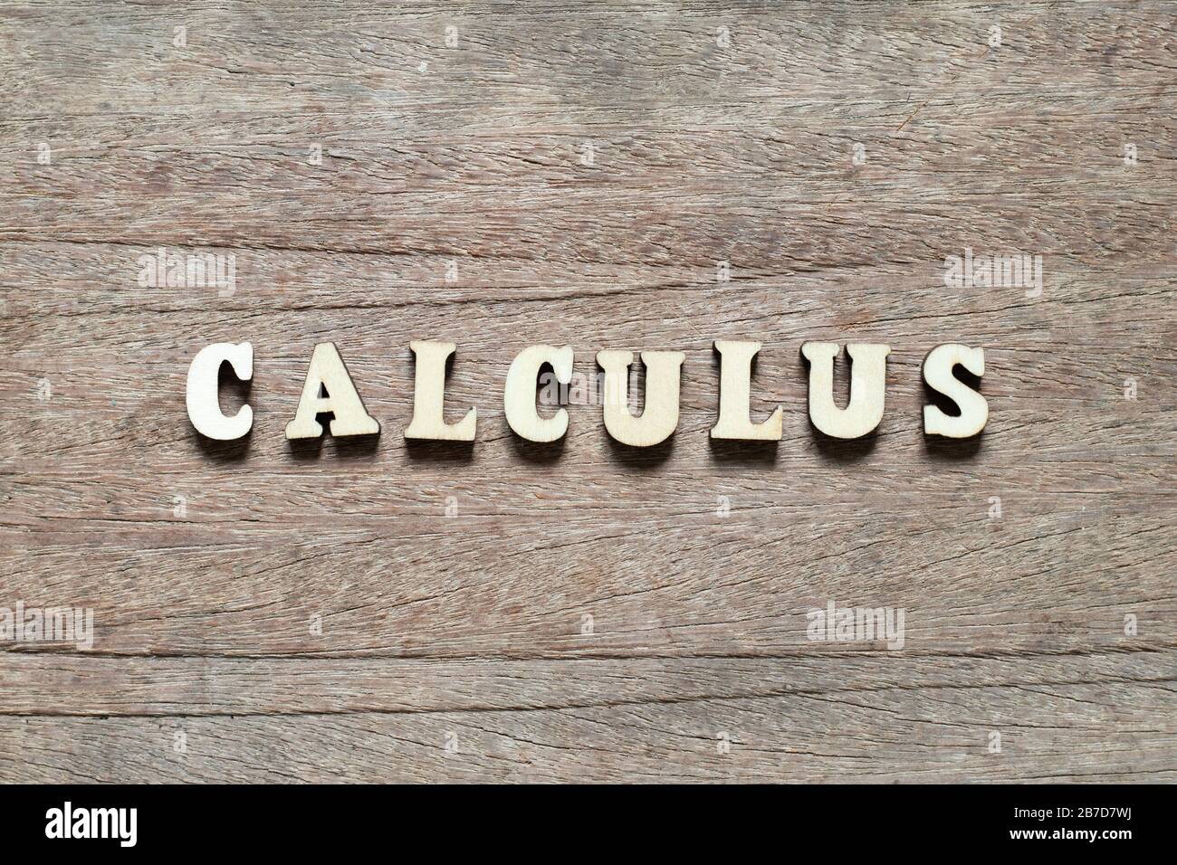 Letter block in word calculus on wood background Stock Photo - Alamy