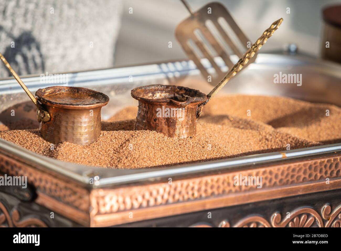 Preparation of Turkish coffee in the cezve in the sand Stock Photo - Alamy
