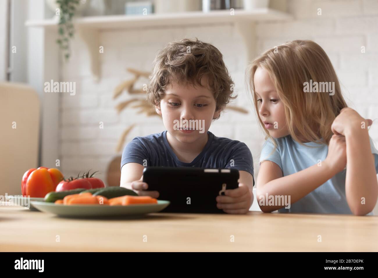 Clever little kids using tablet watching cartoon together Stock Photo ...