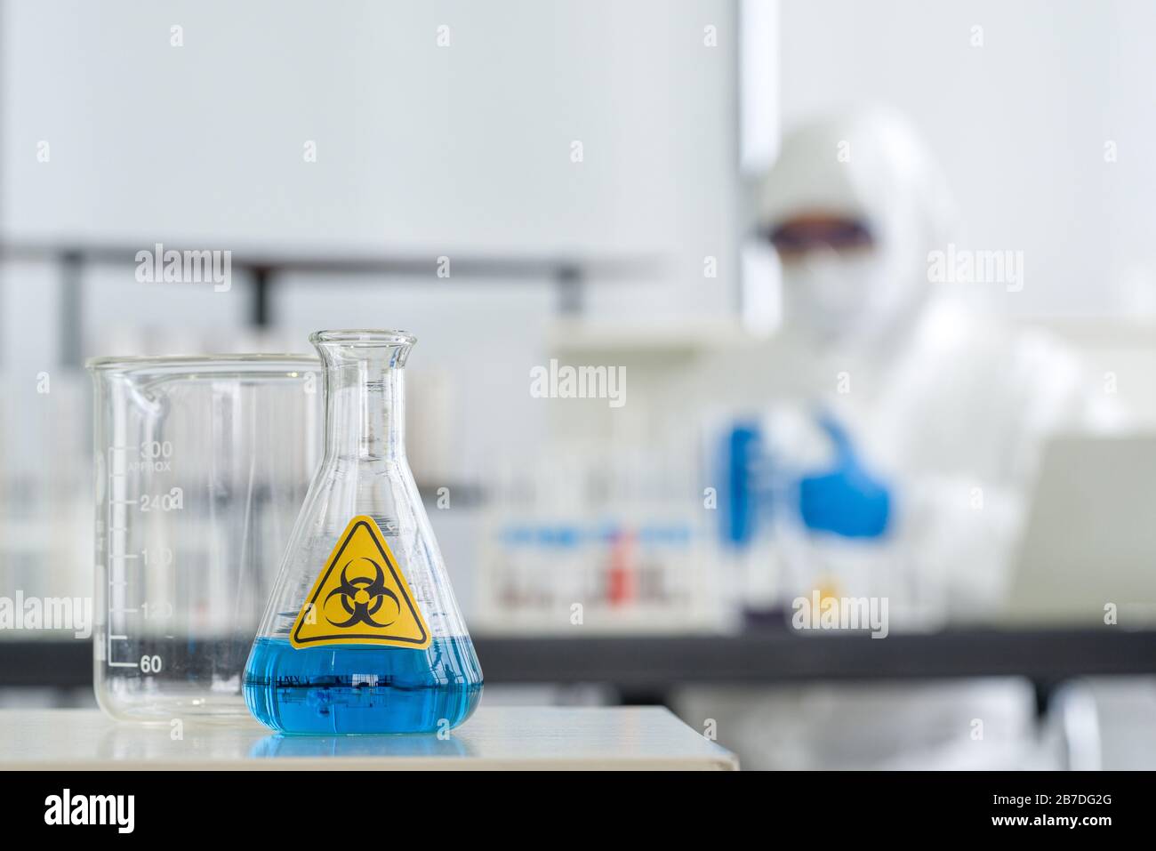 Erlenmeyer Flask contains blue liquid chemicals on a white laboratory ...