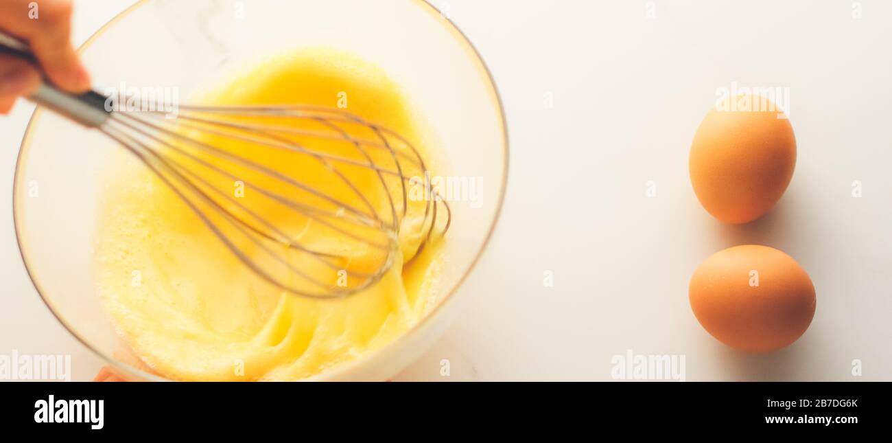 Mixing eggs in bowl on marble table, homemade food recipe concept Stock ...