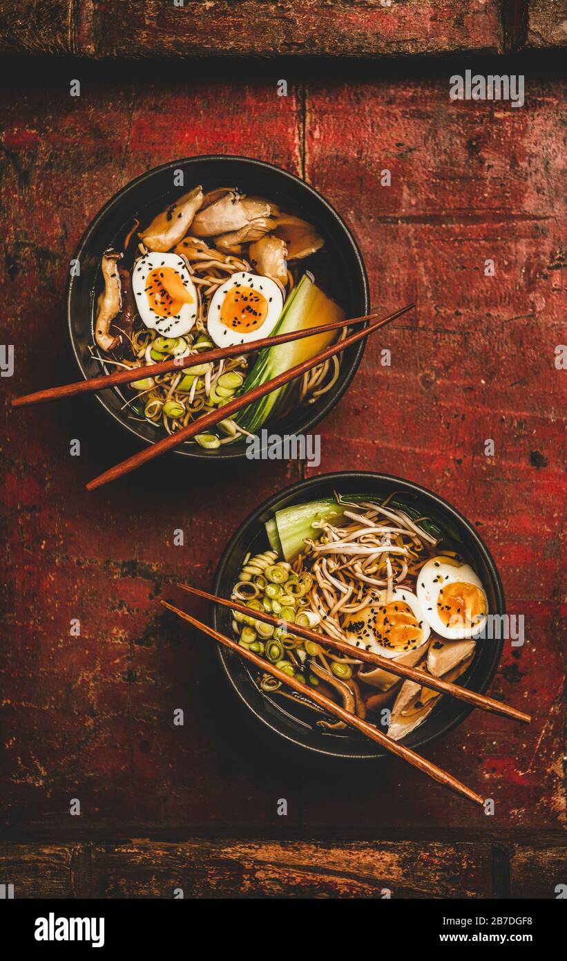 Flat-lay of traditional japanese Ramen bowls with chicken meat and ...
