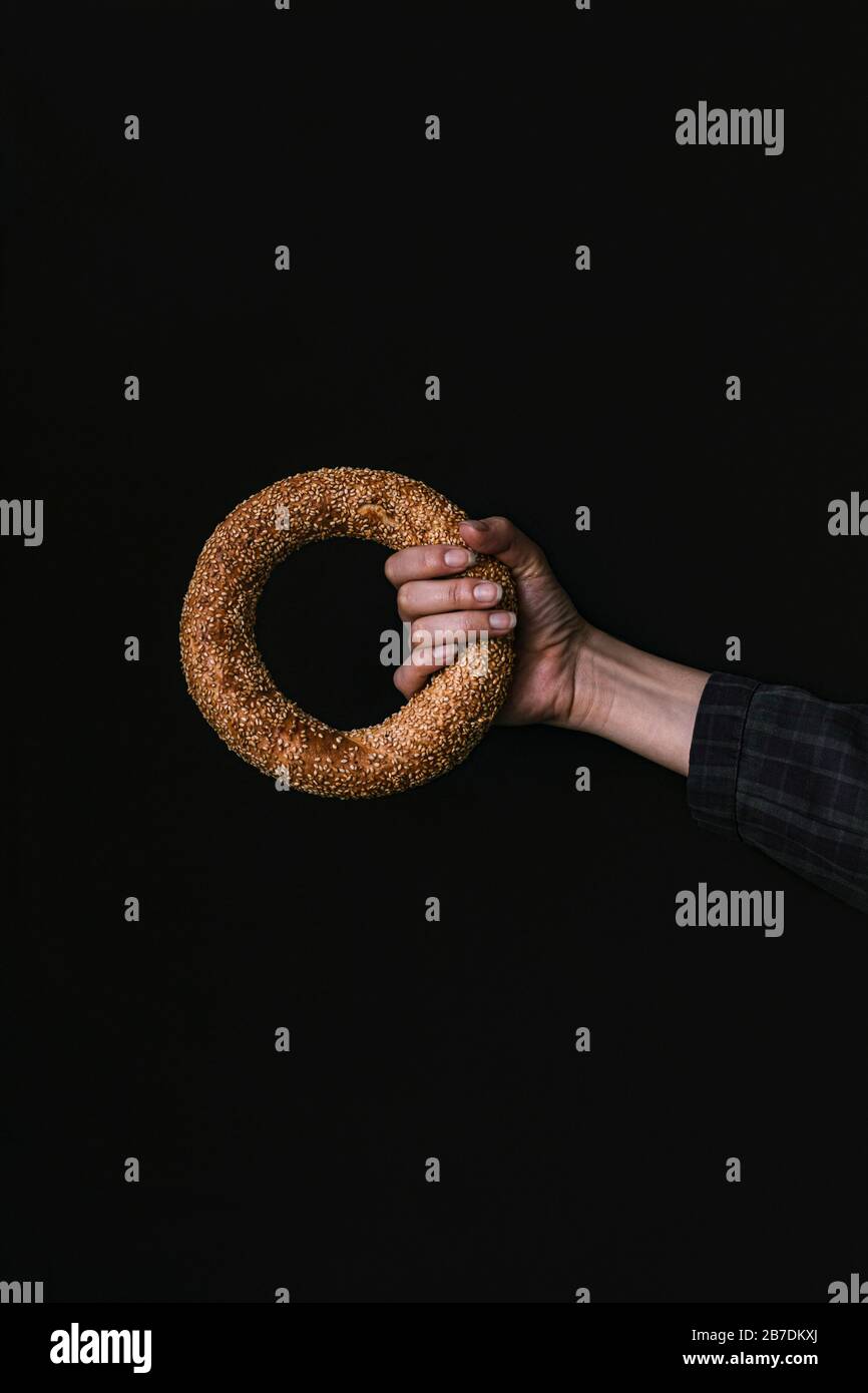 Hand holding bagel hi-res stock photography and images - Alamy