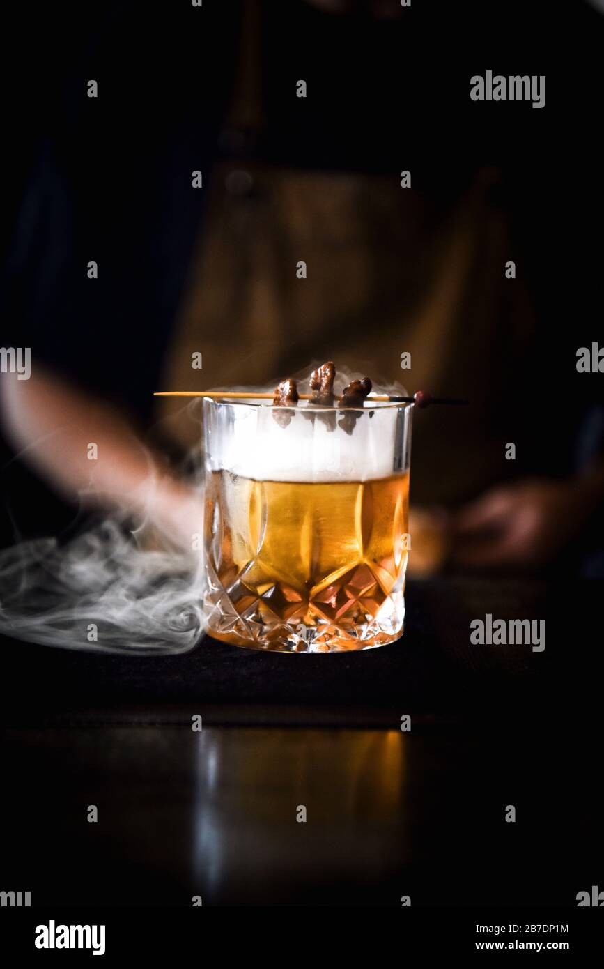 Smoking Cocktail on a bar with a bartender Stock Photo - Alamy