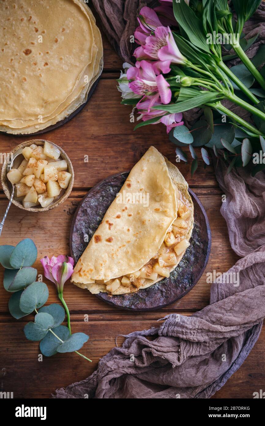 Crêpes filled with sauteed cinnamon and maple syrup apples Stock Photo ...