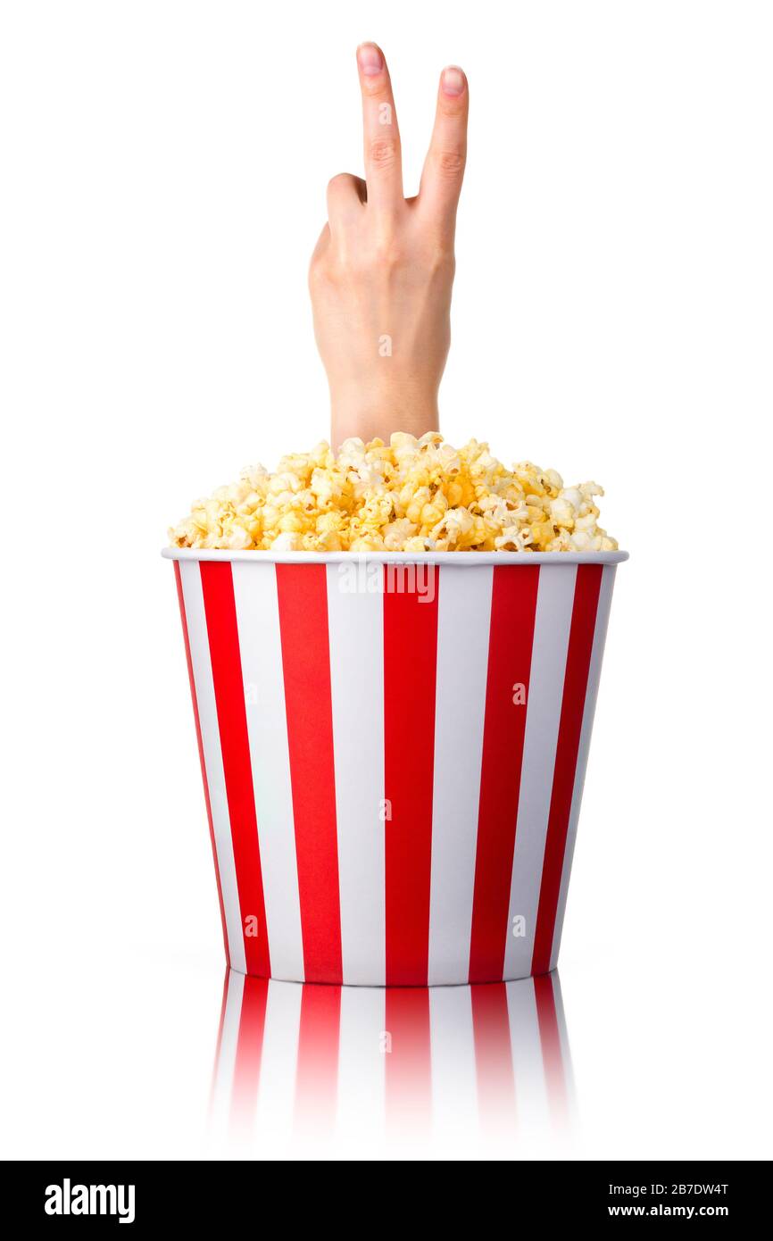 Female hand sticks out of a bucket with popcorn isolated on white ...