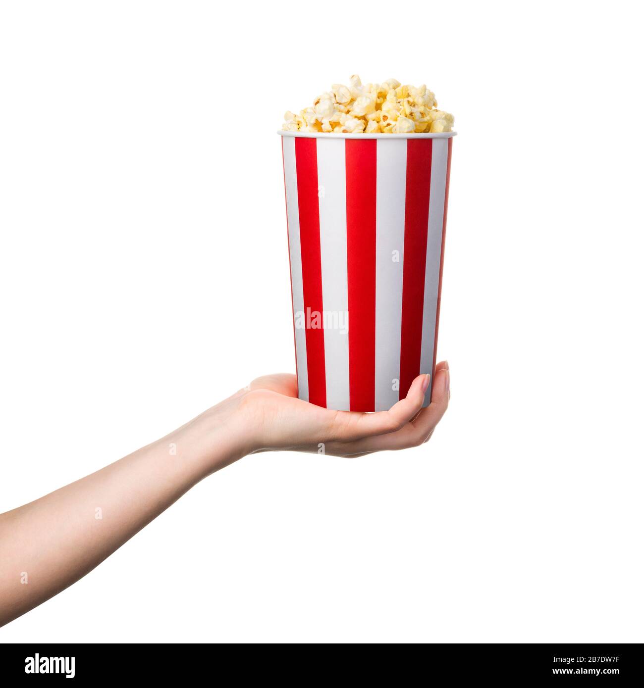Woman hand holding striped bucket with popcorn isolated on white ...