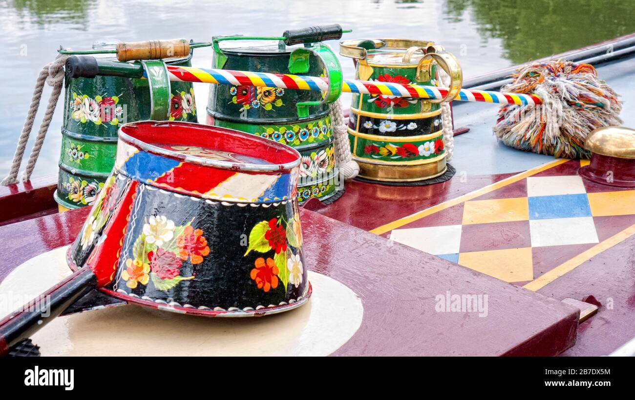 Brightly colour water cans and mop on roof of Historic Narrowboat, in ...