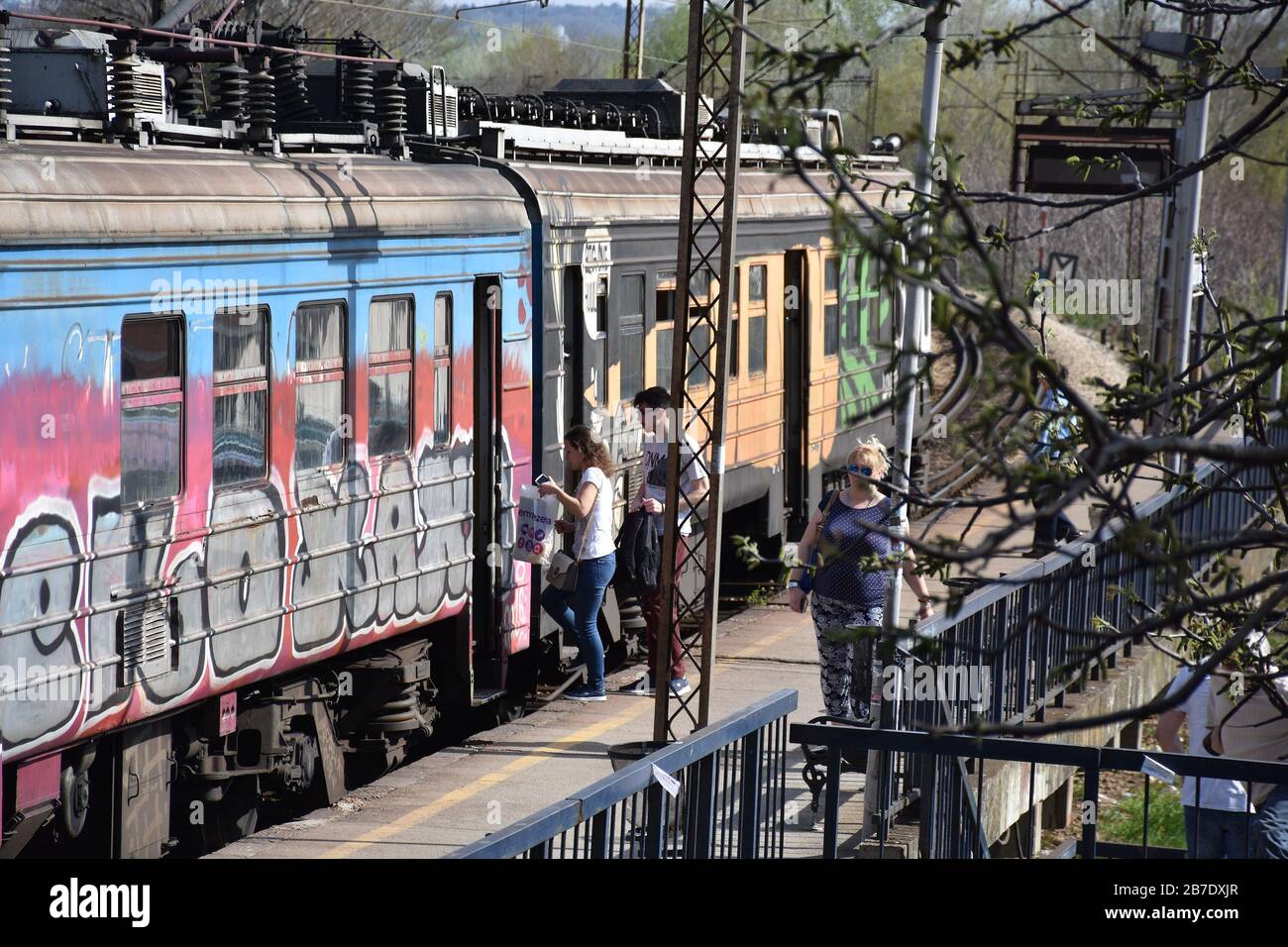 Passengers board the train at the train station Stock Photo - Alamy