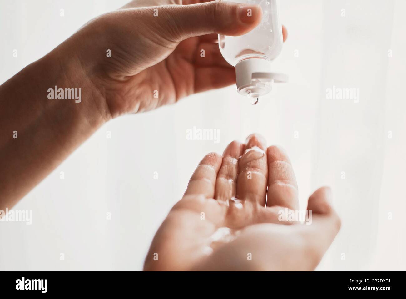 Hands disinfection. Applying disinfection alcohol gel on hands palm to ...