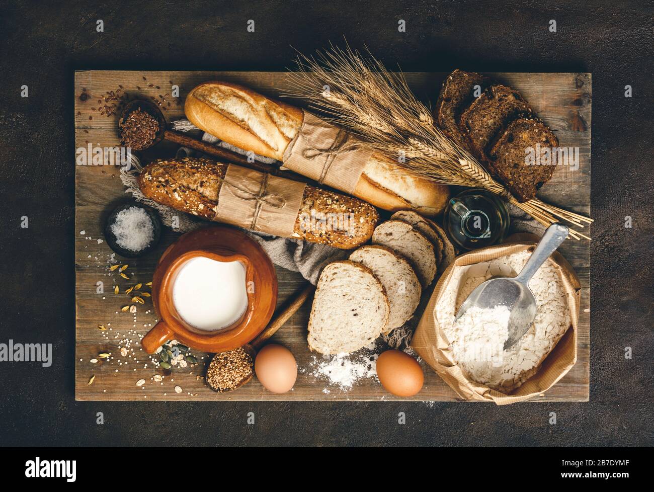 Various bread selection and baking ingredients flat-lay. Top view of ...