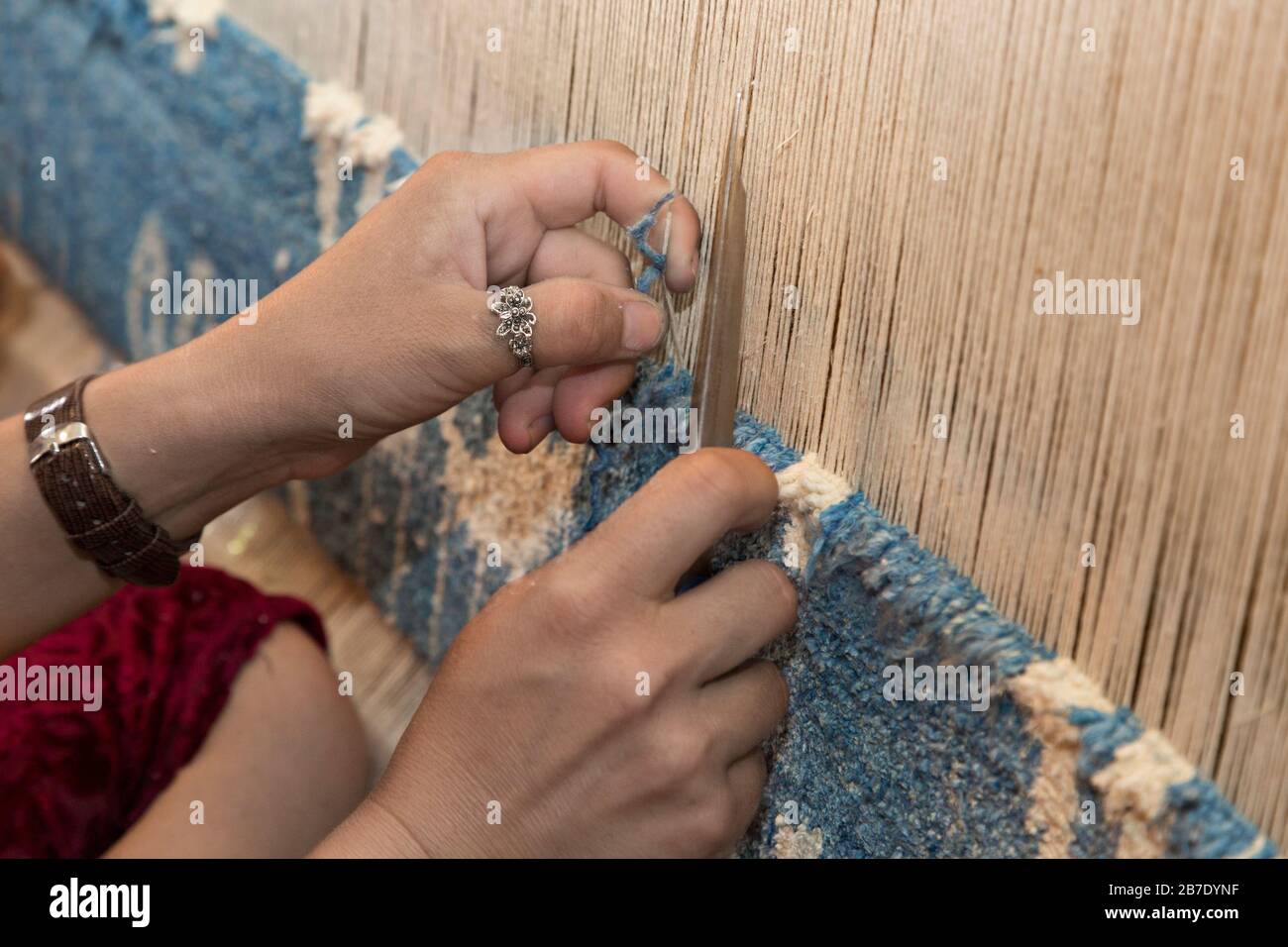 Woman hands weaving carpet on the loom, in Margilan, Uzbekistan Stock ...