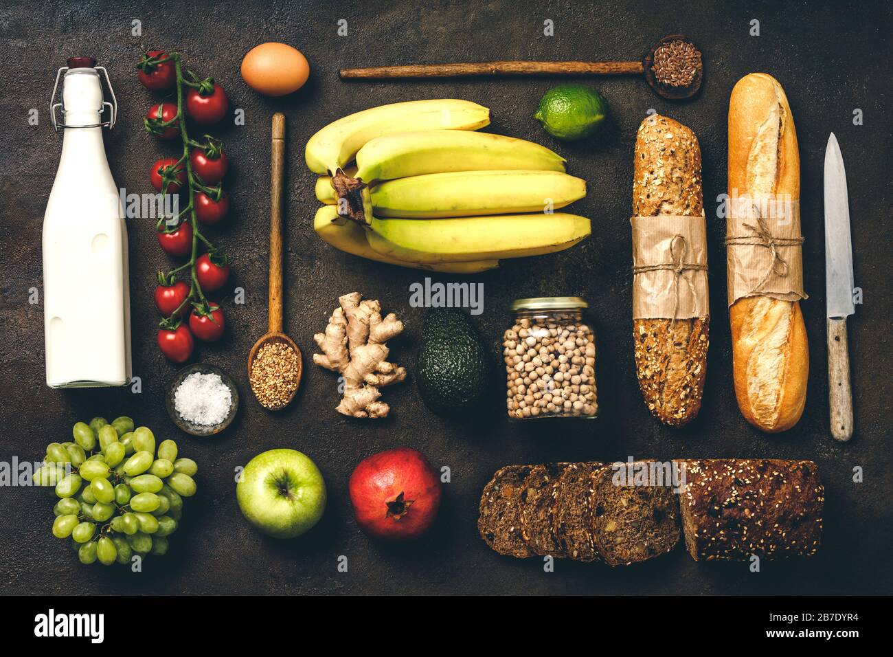 Flat lay of healthy food - milk, bread, fruits, vegetables, grains and ...