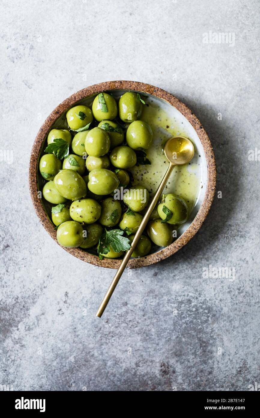 Green olives in a ceramic bowl Stock Photo - Alamy